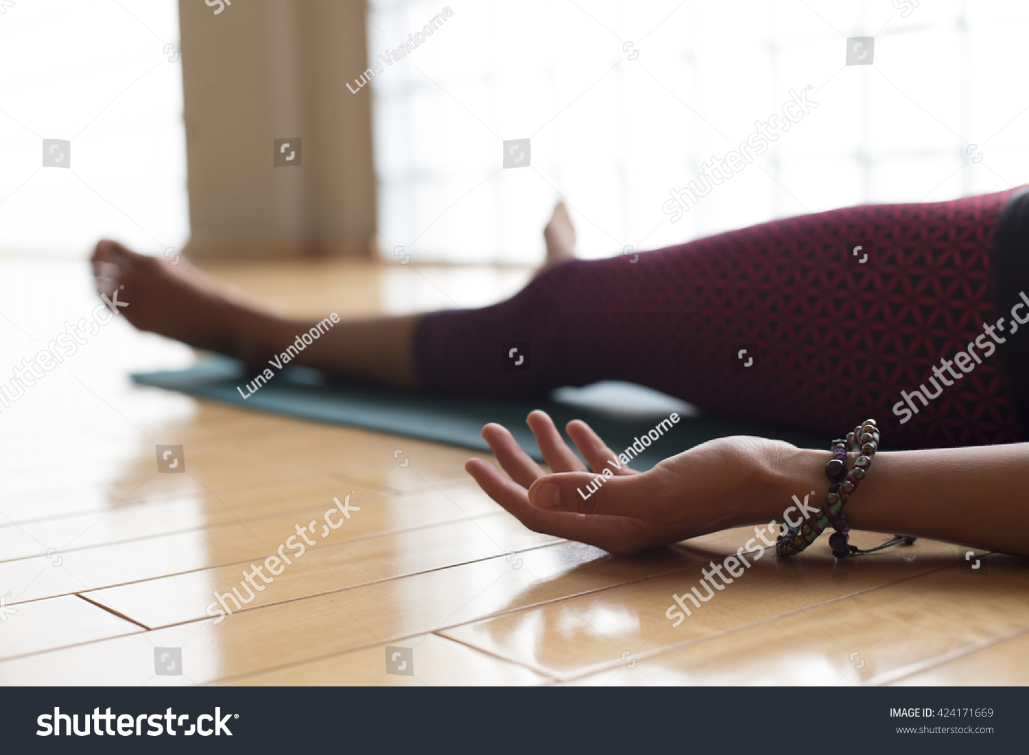 stock-photo-beautiful-woman-lying-down-in-her-yoga-mat-during-shavasana ...