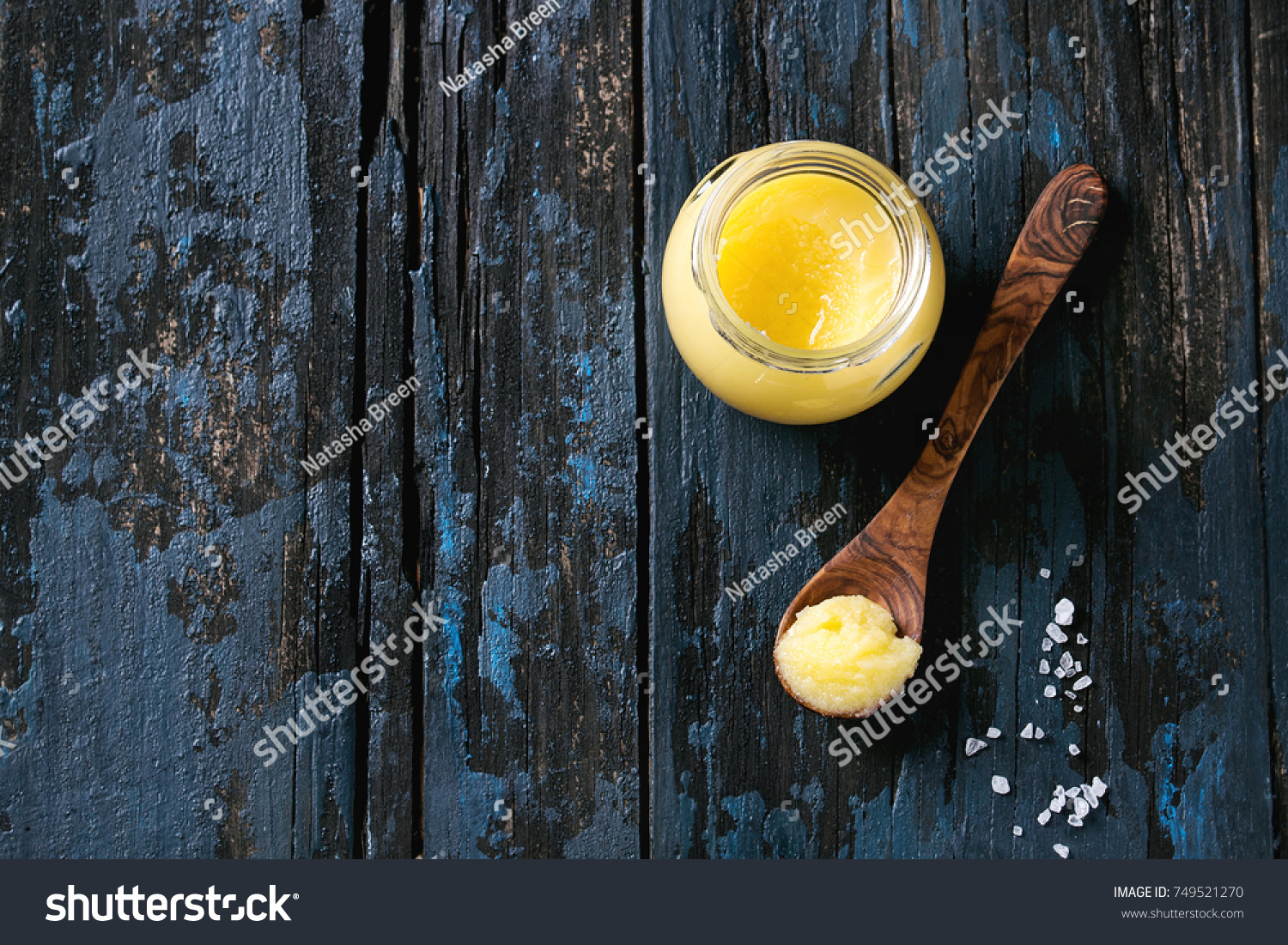 stock-photo-glass-of-salted-drawn-ghee-butter-standing-with-wood-spoon ...